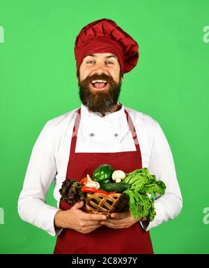 Man with beard holds wicker bowl with fruit Stock Photo - Alamy