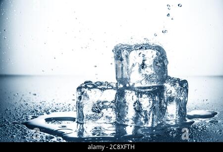 ice cube in water puddle Stock Photo - Alamy