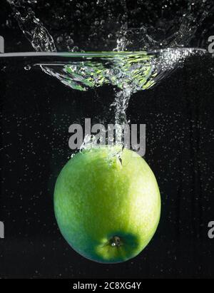 Apple fruit surrounded with water splash Stock Photo - Alamy