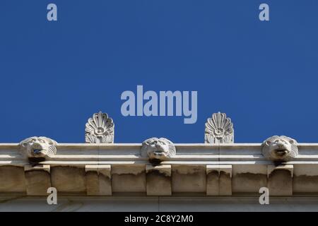 Ancient rain gutter downspout in rusted metal in shape of the head of a ...