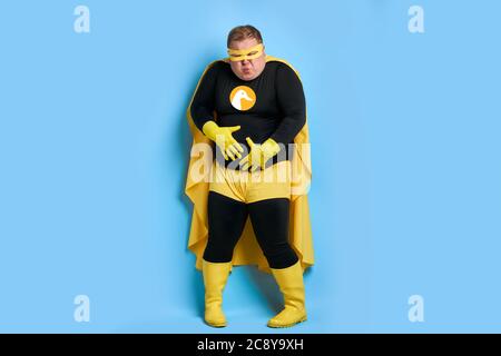 fat caucasian powerful superhero man show how strong he is, man holds ...