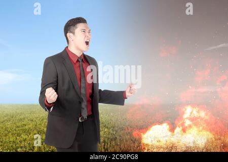 Asian businessman angry looking at burning ground on the field. Concept ...
