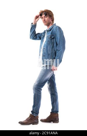 Confident redhead man in glasses pointing fingers down, staring daring ...