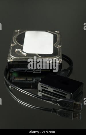 Universal card reader and hard drive isolated on black background Stock ...