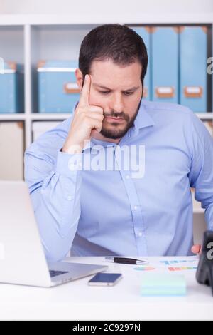 Vertical shot of a Caucasian man working in the office Stock Photo - Alamy