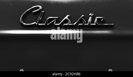 A closeup view of the word classic written as a chrome emblem in a ...