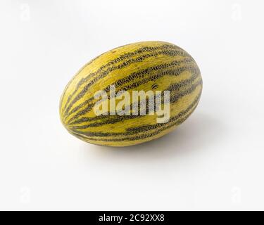 Striped yellow with green stripes an oblong melon with a carved slice ...