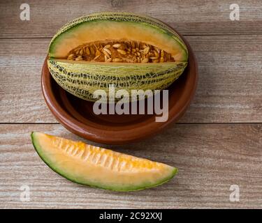 Striped yellow with green stripes oblong melon on a white background ...