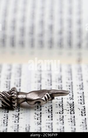 A silver Yad Jewish ritual pointer, a Jewish star (Star of David) and a ...