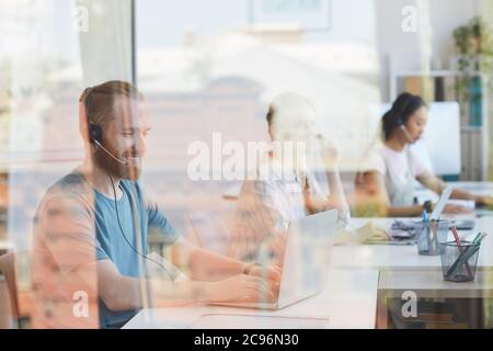 Working business people behind glass walls Stock Photo - Alamy