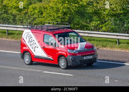 2019 red Citroen Berlingo car driving in the rain on a wet road Stock ...