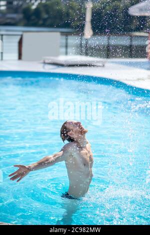 Man with outstretched arms and a bright smile showing open posture in ...