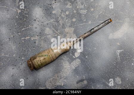 Old used and rusted wood chisel with a translucent handle isolated on a ...