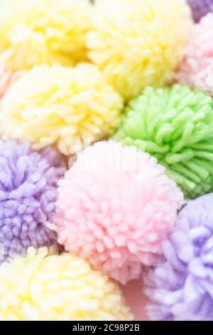 Pastel color pom poms on a pink background Stock Photo - Alamy