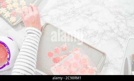 Flat lay. Step by step. Poping chocolate snowflakes from the plastic ...