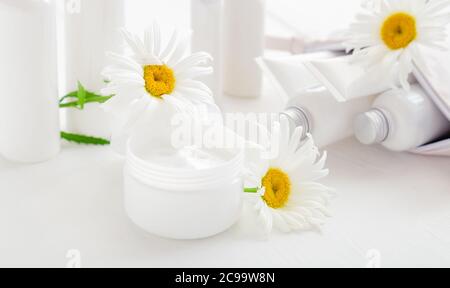Jar of natural cream with chamomile flowers on white background Stock ...