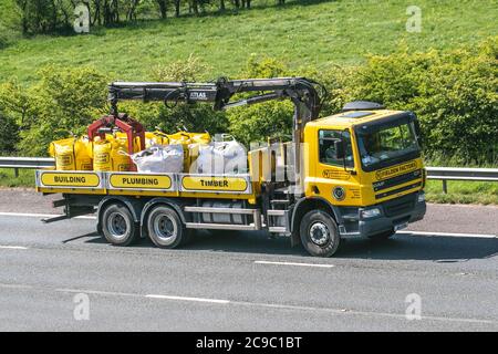 a construction or builders merchants delivery lorry at a building site ...