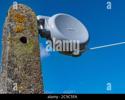 Washing line attached to a concrete post hook in a garden / yard, with ...