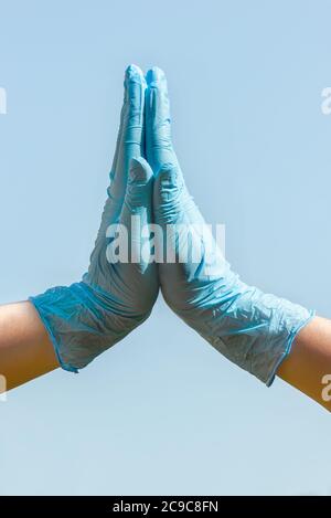 Two blue surgical gloves with open middle finger, isolated Stock Photo ...