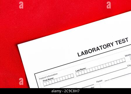 Laboratory form to fill in with results of blood test and red tube with ...