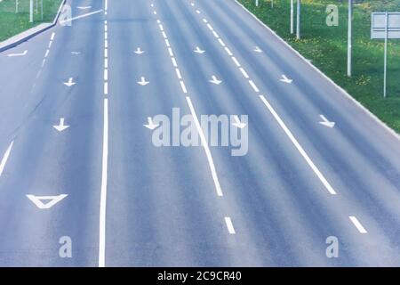 Four paved lanes with traffic arrows directing traffic in various ...