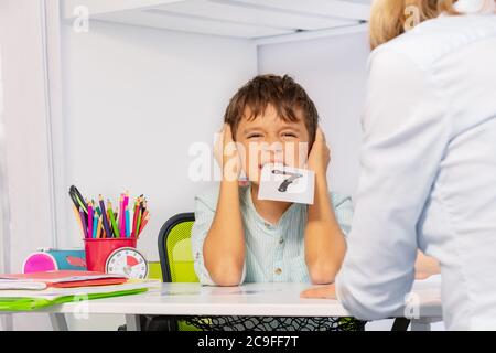 Boy with autism spectrum disorder bite hand and negative expression ...