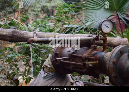 A selective focus shot of an old gas pump ornament hanging on a ...