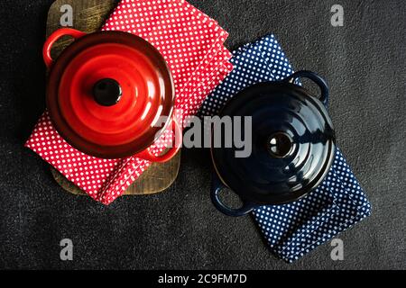 Cooking concept with ceramic pots and towels on dark concrete ...