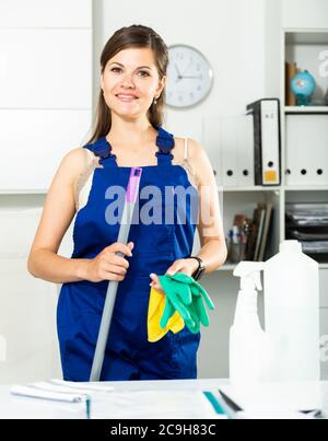 Female office cleaner is satisfied after cleaning Stock Photo - Alamy