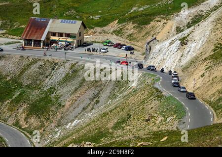 Bendy, twisty road with mountains and vehicles, Galibier Pass, French ...