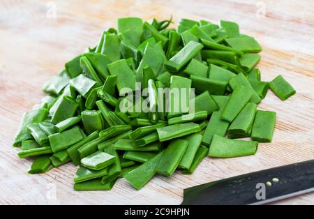 Sliced green helda beans on wooden surface. Organic vegetables for ...