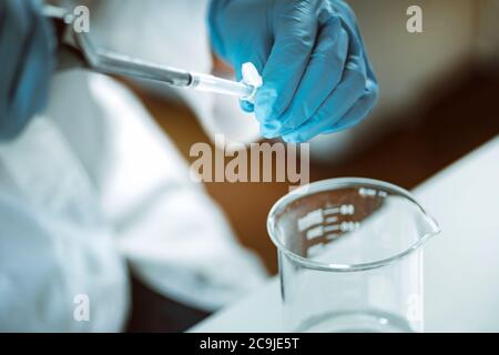 Microbiology. Hands of a microbiologist pipetting sample Stock Photo ...