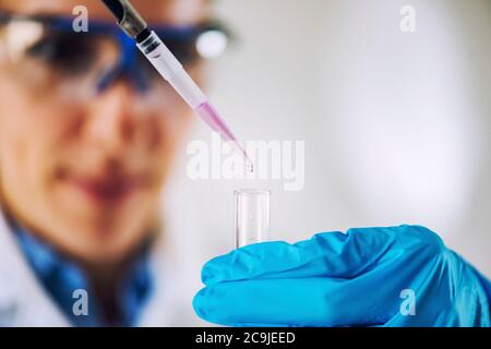 Laboratory technician with micro pipette Stock Photo - Alamy