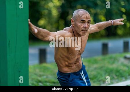 Fit senior man exercising in a park Stock Photo - Alamy