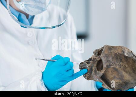 Ancient DNA analysis. Female scientist holding micro tube with sample ...