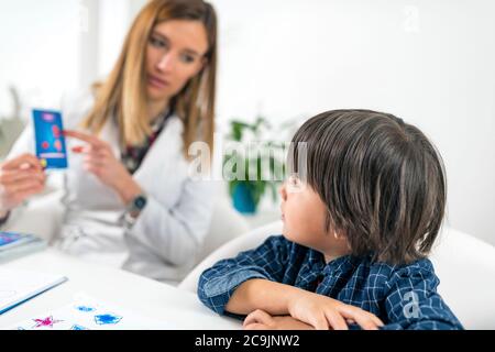 Psychology test for children. Toddler undergoing a logic test with ...