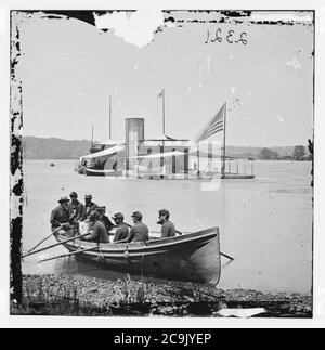 River landscape, in the foreground a rowboat pulled up on land ...