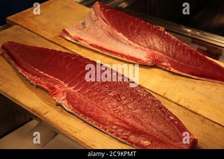 Slabs of freshly sliced tuna in a Tokyo Fish market. Tuna is well ...