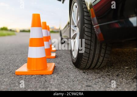 Car and orange traffic cones, lesson in driving school concept, nobody ...