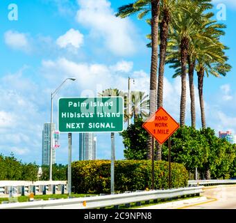 Miami road sign on cloudy sky background Stock Photo - Alamy