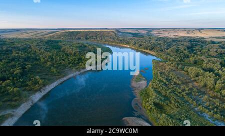 Aerial drone view of morning haze and mist above village houses ...