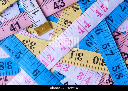 Measuring tape on blue background Stock Photo - Alamy