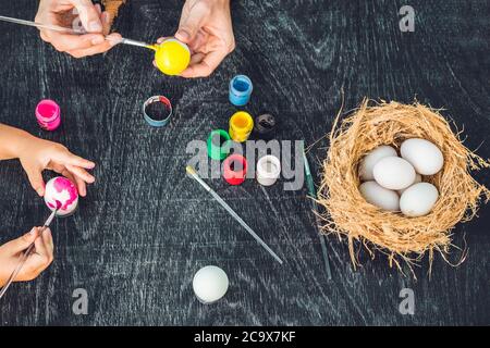 Happy Easter. A mother and her son painting Easter eggs Stock Photo - Alamy