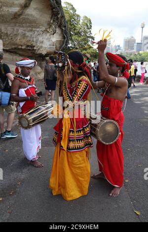 A Chitrasena Dance Company dancer helps another dancer take off his ...