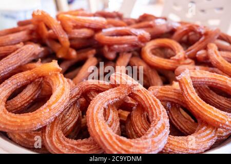 Turkish Dessert Churros Halka Tatli frying in hot oil. Turkish ...