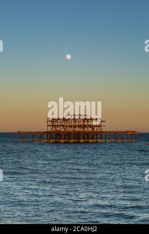 A full moon visible at sunset, over the sea at Brighton Stock Photo - Alamy