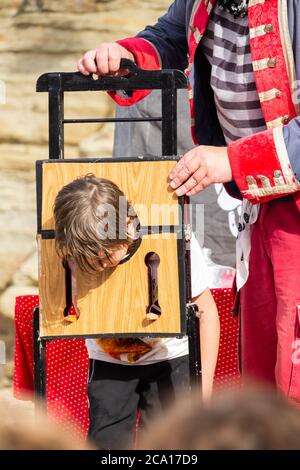 Children's entertainer using young boy in audience for Guillotine ...