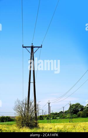 Old power cables and comm lines with wooden poles Stock Photo - Alamy