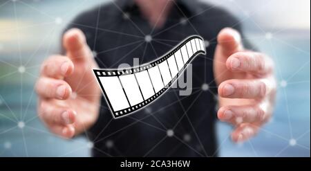 Movies, video and cinema concept between hands of a man in background ...