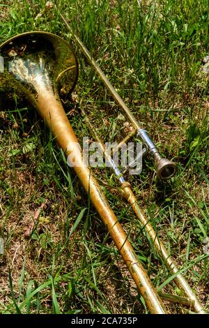Old rusty trombone lays in grass field at music festival Stock Photo ...